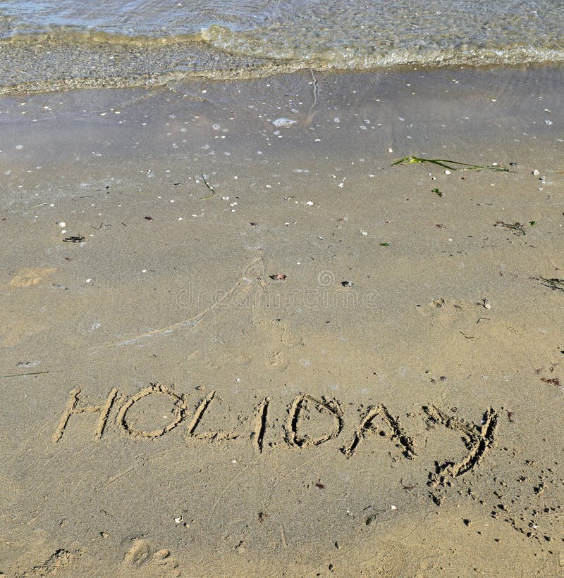 Large Capital Letters Text HOLIDAY on the Sand of the Beach Stock Photo ...