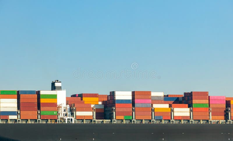 Large Cargo Container Ship Loaded with Containers Against the Blue Sky ...