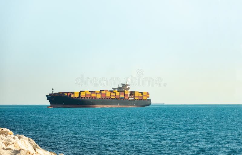 Large Cargo Container Ship Loaded with Containers Against the Blue Sky ...