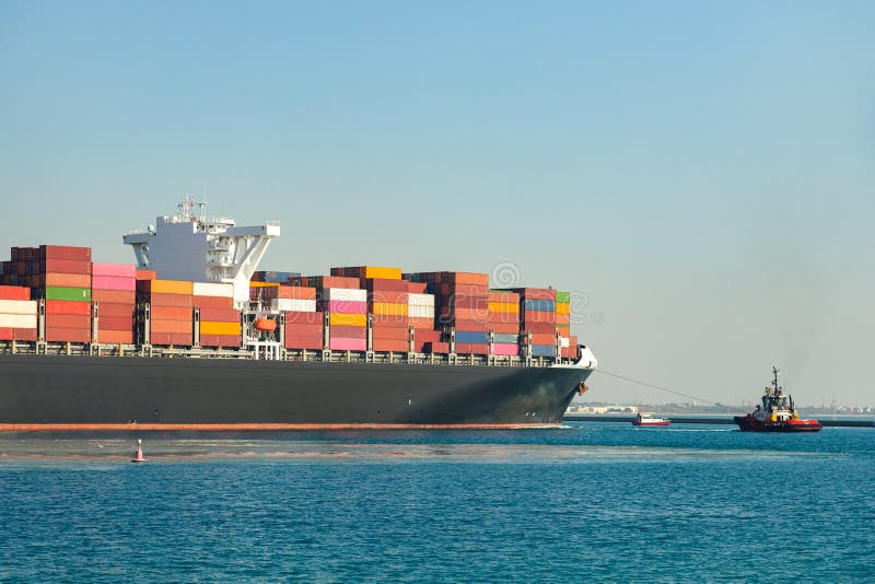 Large Cargo Container Ship Loaded with Containers Against the Blue Sky ...