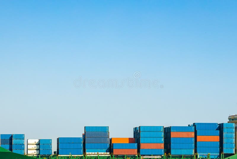 A Large Cargo Container Ship Loaded with Containers Against the Blue ...