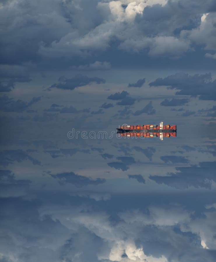 Large Cargo Ship Over the Horizon at Dusk with Reflection Stock Photo ...
