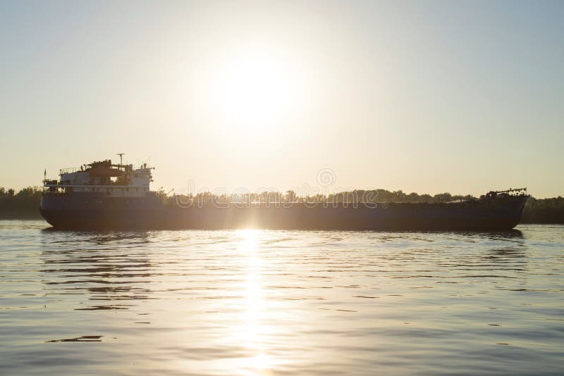 Large Cargo Ship Sailing in Still Water. Cargo Ship Sailing Against ...
