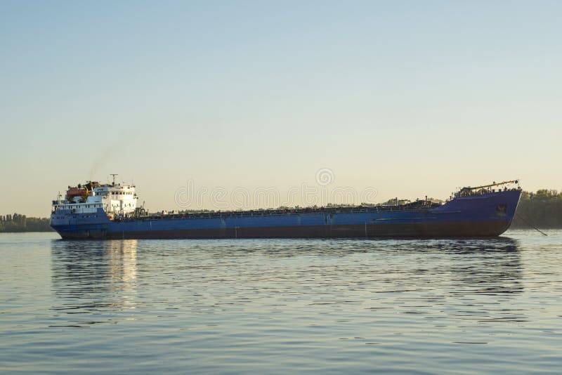 Large Cargo Ship Sailing in Still Water. Cargo Ship on the River Stock ...