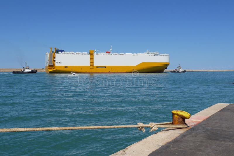 Large Cargo Ship Towed into Port by Two Small Tugboats Editorial Stock ...