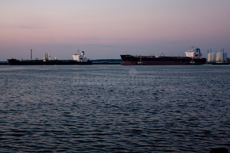Large Cargo Ships Navigating a Calm Evening Harbor with Purple Horizon ...