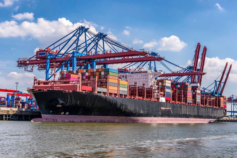Large Cargo Vessel Docked at a Port, with Several Gantry Cranes Visible ...