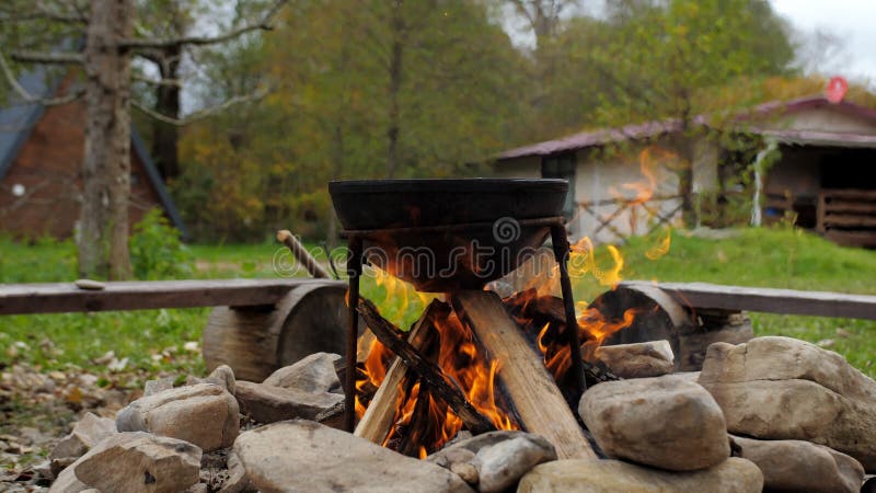 A Large Cast-iron Cauldron is Heated Over a Fire. Cooking Over a ...