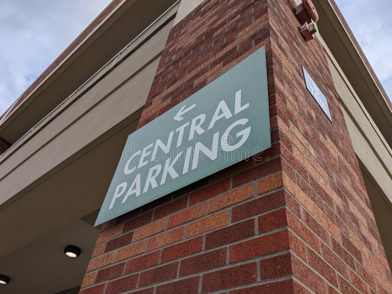 A Large `Central Parking` Sign on a Brick Wall Outside a Parking Garage ...