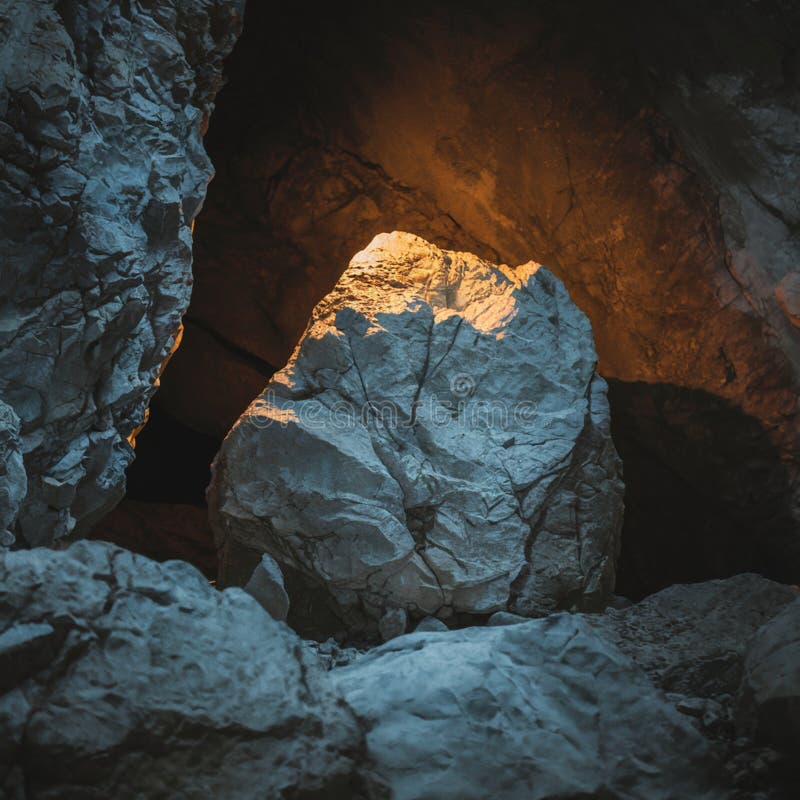 Large Central Stone Illuminated by Warm Light, Contrasting Cool Cave ...
