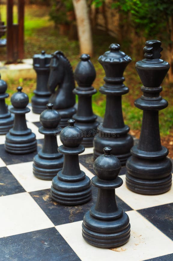 A Large Chess Board Featuring Oversized Giant Chess Pieces Placed on it ...
