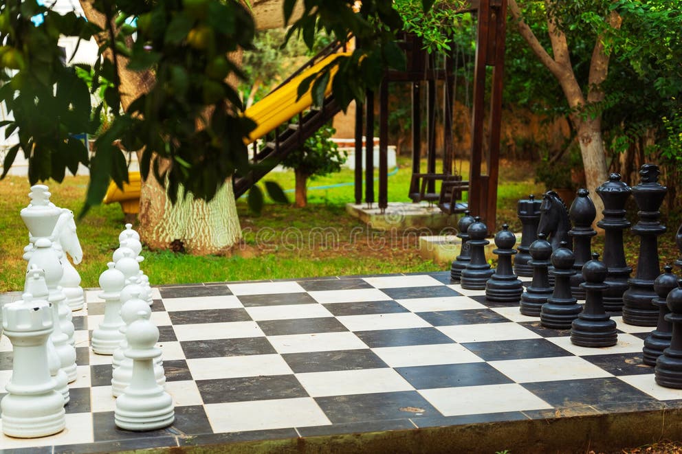 A Large Chess Board Featuring Oversized Giant Chess Pieces Placed on it ...