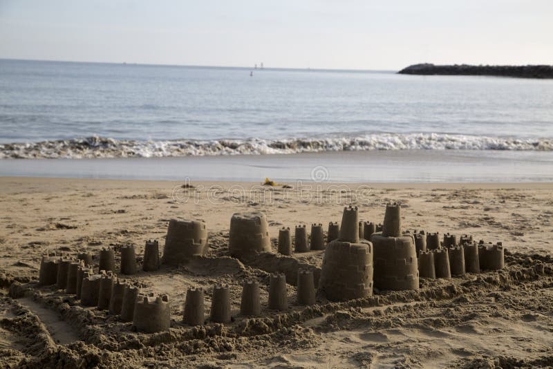 Large Children S Sand Castle on the Beach Small Ocean Waves Stock Image ...