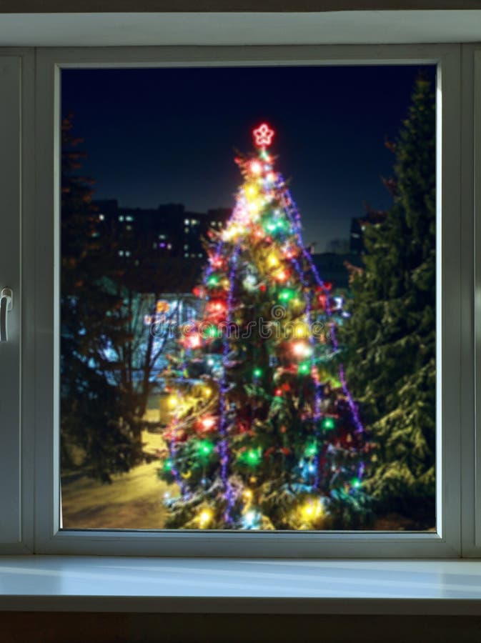 A Large Christmas Tree Outside the Window Stock Photo - Image of ...