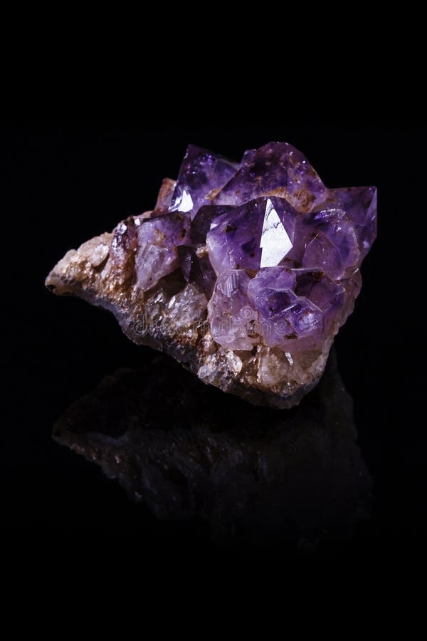 Large Chunk of Amethyst Crystal on a Reflective Black Surface Stock ...