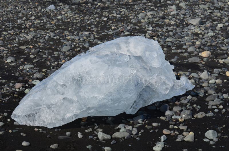 Large Chunk of Ice on Black Stone Beach Stock Photo - Image of lake ...