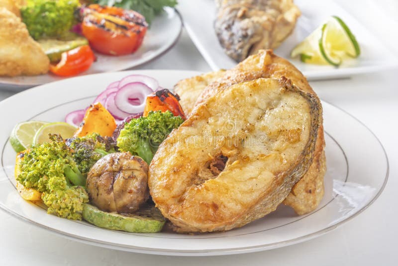 Large Chunks of Fried Fish - Pike Perch with Grilled Vegetables. Stock ...