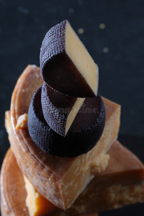 Large Chunks of Hard Cheese on a Black Background. Wine Cheese. the ...