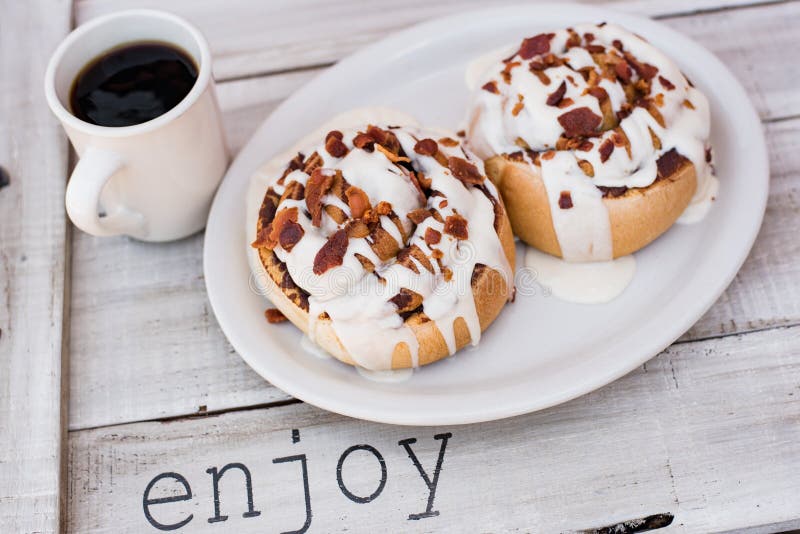 Large Bacon Cinnamon Rolls with a Cup of Coffee Stock Photo - Image of ...