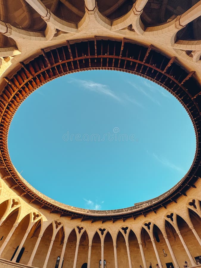 A Large, Circular Building with a Blue Sky Above it Stock Image - Image ...