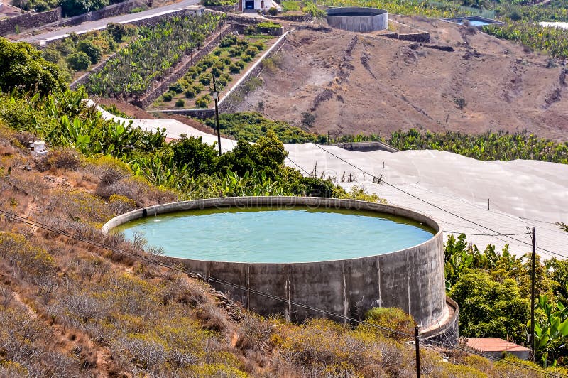 A Large, Circular Pool of Water Sits on a Hillside Stock Image - Image ...