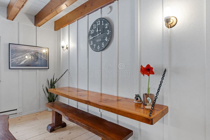 Large Clock Above a Long Bench in the Living Room Stock Photo - Image ...