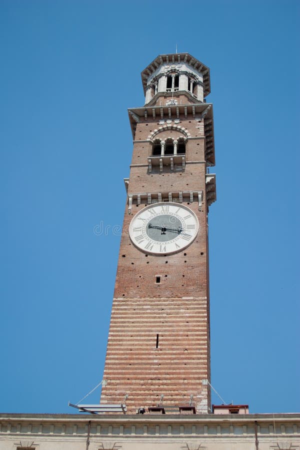 A Tall and Ornate Brickwork Clock Tower in a Typical Tuscan Town in ...