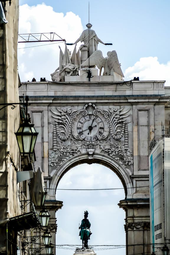 A Large Clock Tower with a Statue of a Man on Top Stock Image - Image ...
