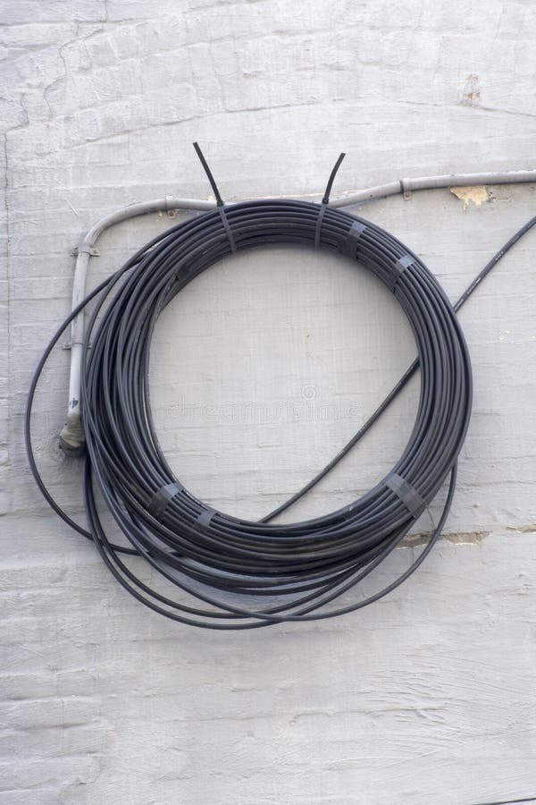 Cable coil on wall stock photo. Image of conduit, wire - 123846062