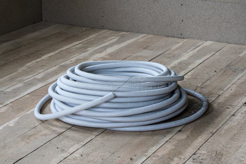 A Large Coil of Plastic Corrugation for Electrical Cables Lies on the ...