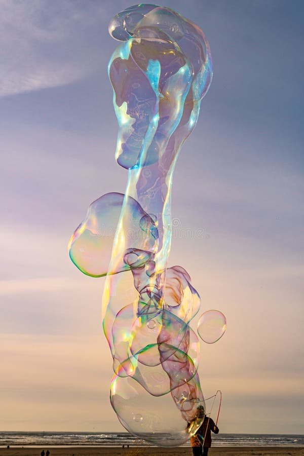 Large Colorful Bubbles on the Beach with Sunlight Refracting through ...