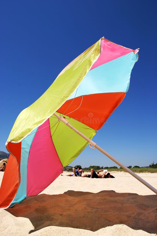 Large Colourful Umbrella on a Sunny Beach in Spain Stock Photo - Image ...
