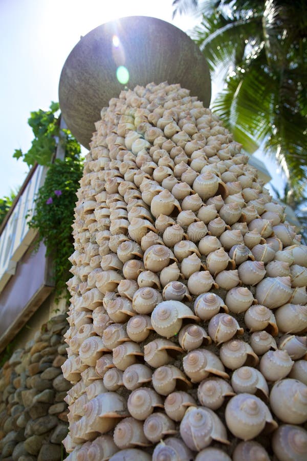 A Large Column of Seashells Rising into the Sky with the Sun`s Rays ...