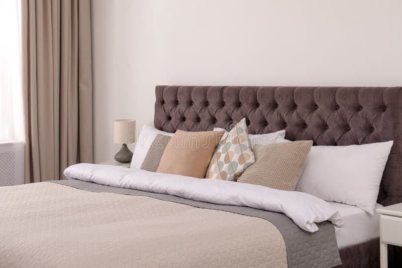 Large Comfortable Bed with Wrought-iron Headboard and Lamp in a Stylish ...