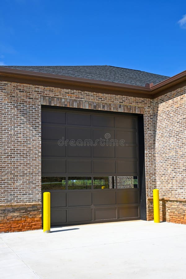 A New Large Commercial Garage Door Stock Photo - Image of concrete ...