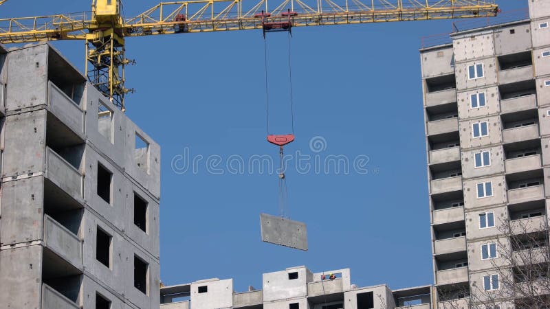 Large Construction Crane Sets Up the Wall on the Building. Stock Photo ...