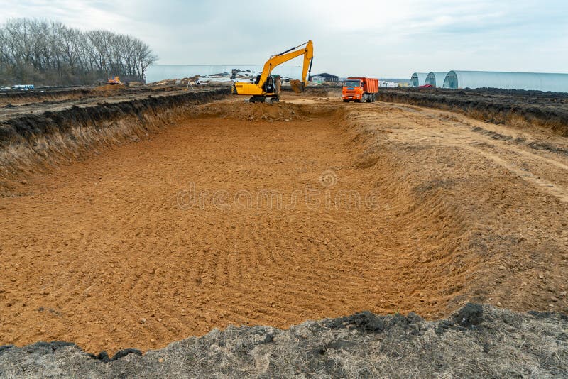A Large Construction Excavator of Yellow Color on the Construction Site ...