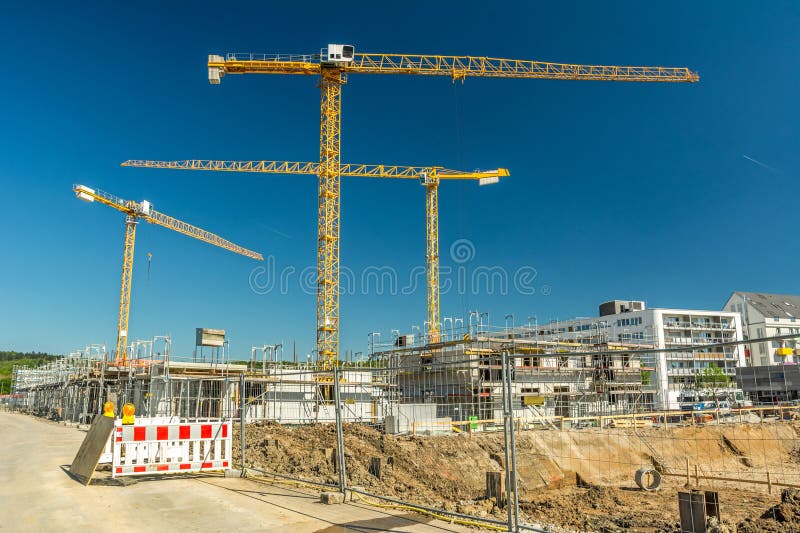Large Construction Site with Cranes, Fence Foundations and Unfinished ...