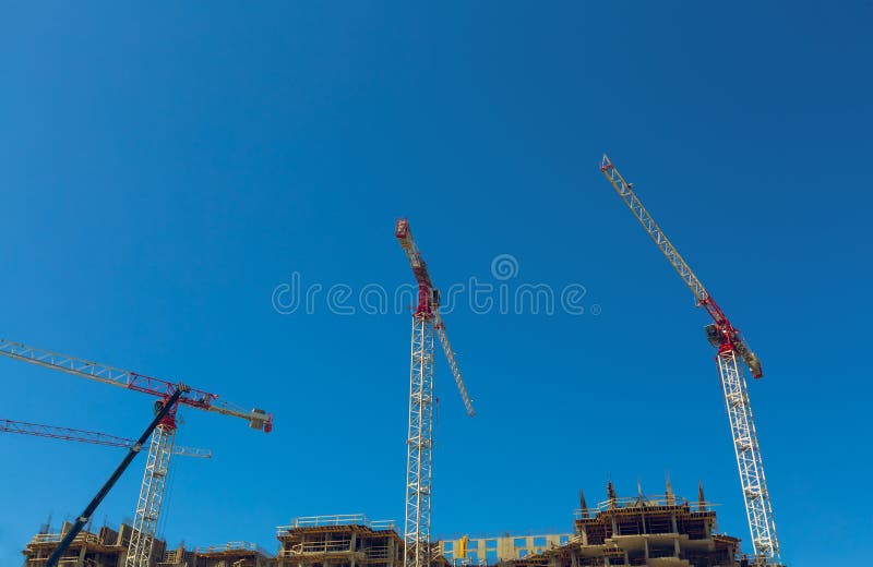 Large Construction Site Including Several Cranes Working on a Building ...