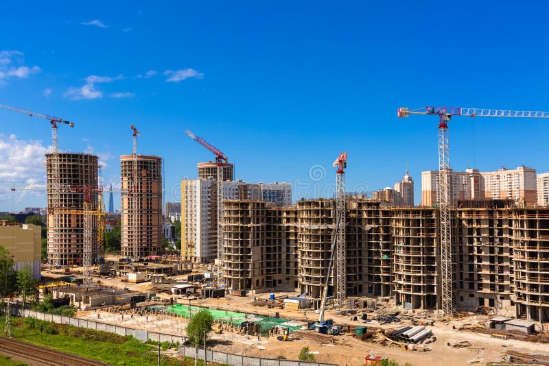 Large Construction Site Including Several Cranes Working on a Building ...