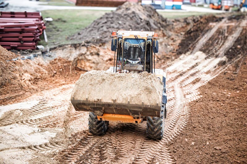 Construction Site in Progress with a Heavy Machinery Performing ...