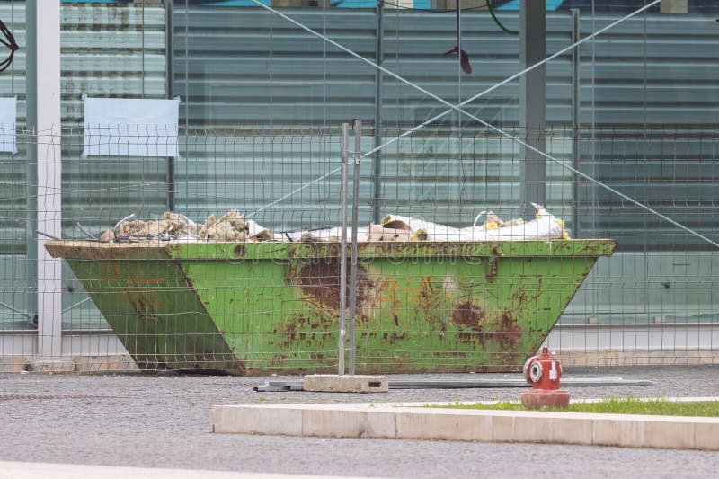 A Large Container Filled with Construction Debris on the Street Stock ...