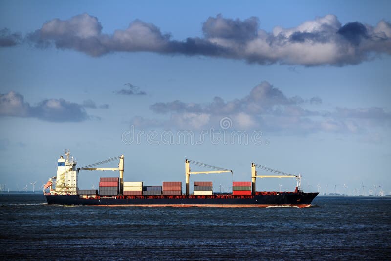 Large Container Ship in the North Sea Under a Cloudy Blue Sky, C Stock ...