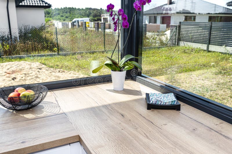 Large Corner Window in a Modern Kitchen with Built-in Cabinets Against ...