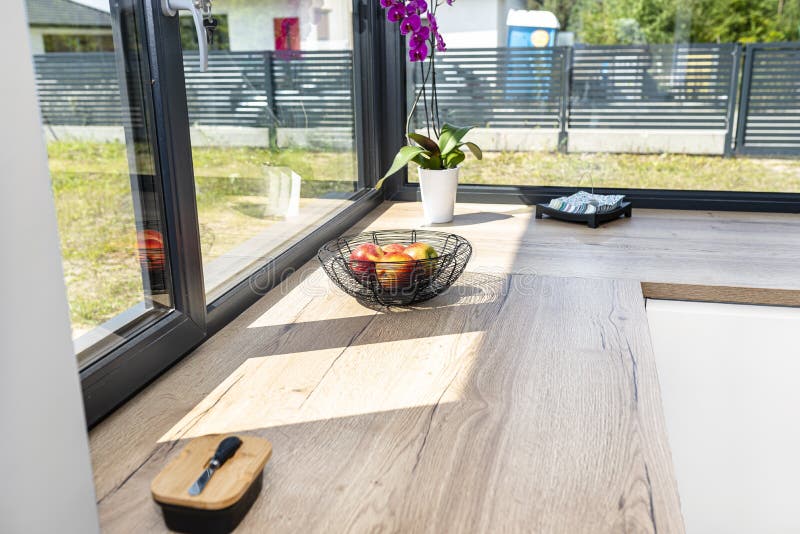 Large Corner Window in a Modern Kitchen with Built-in Cabinets Against ...