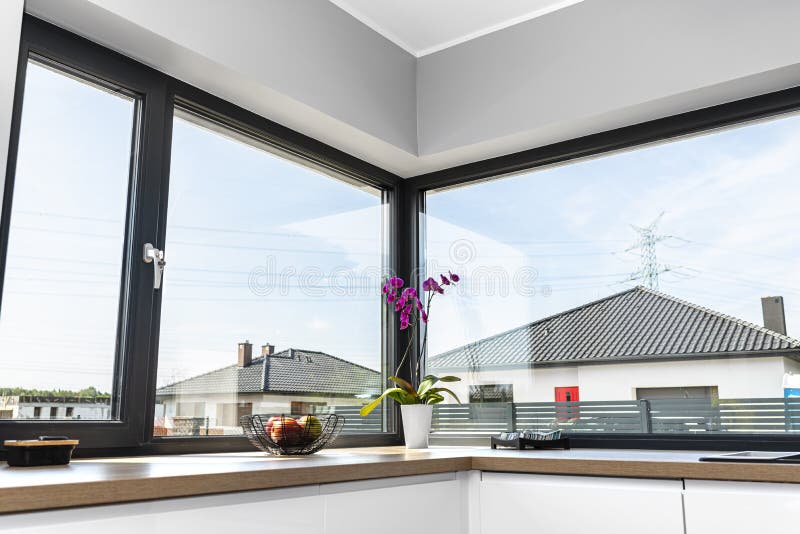 Large Corner Window in a Modern Kitchen with Built-in Cabinets Against ...