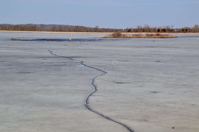 Large Crack Running through Ice Covered Lake at Tiny Marsh Stock Photo ...