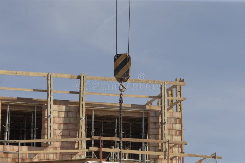 A Large Crane is Carefully Lifting a Brick Building on a Busy ...