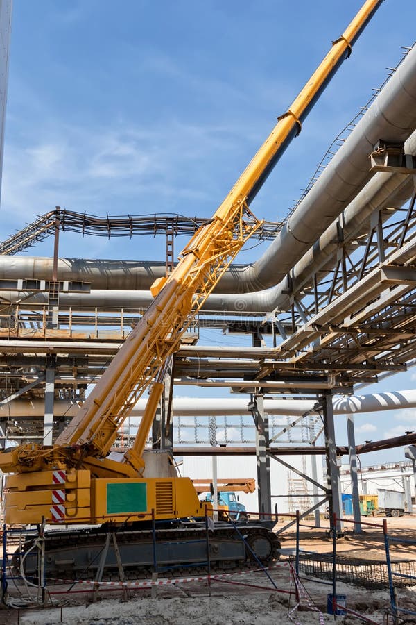 Large Crane on a Crawler is on the Construction Site of the Refinery ...