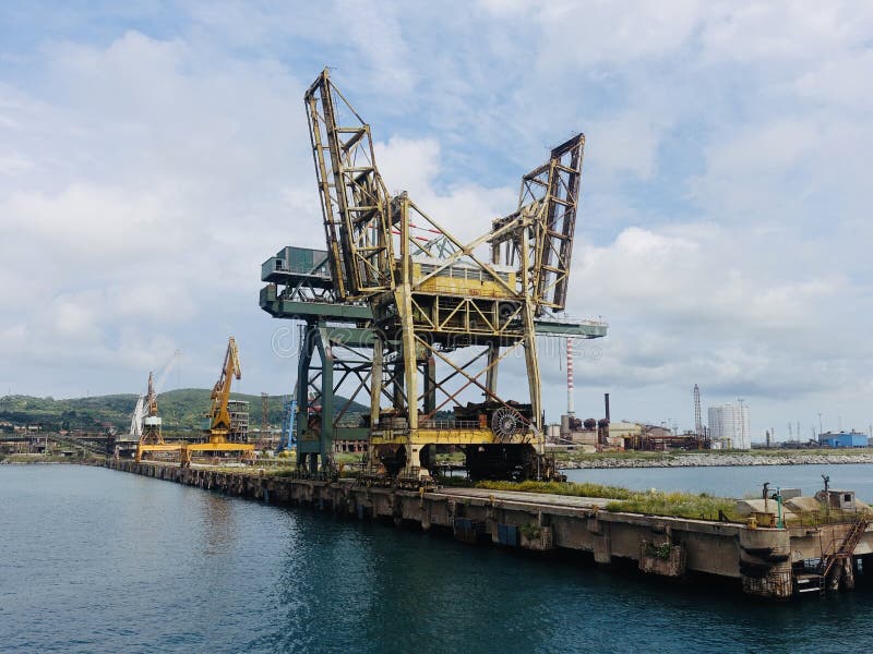 A Large Crane in a Large Body of Water Under a Cloudy Sky Stock Image ...